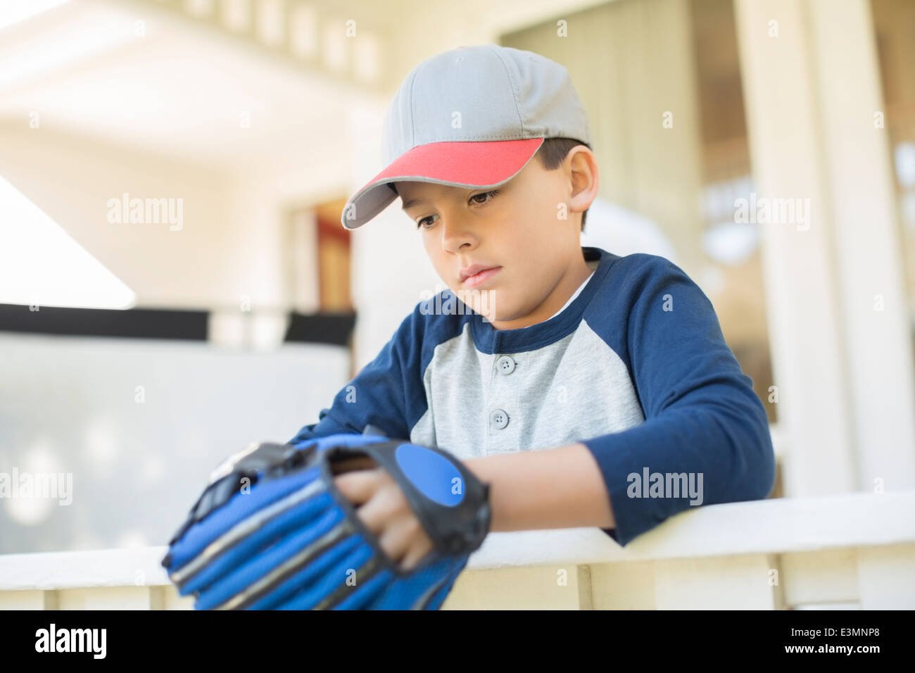 Serious boy with baseball glove Stock Photo - Alamy