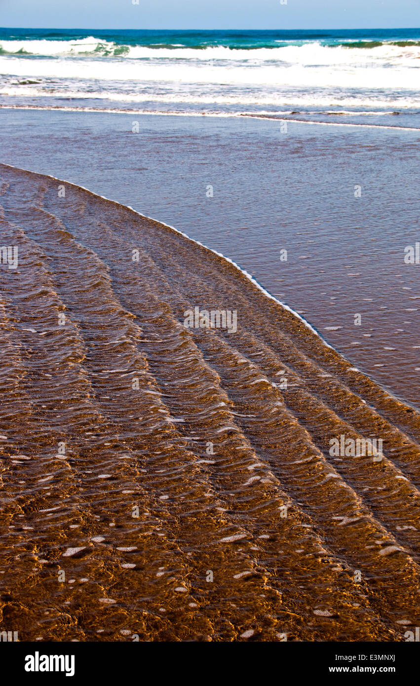 river flowing into sea on wild coastline Stock Photo - Alamy