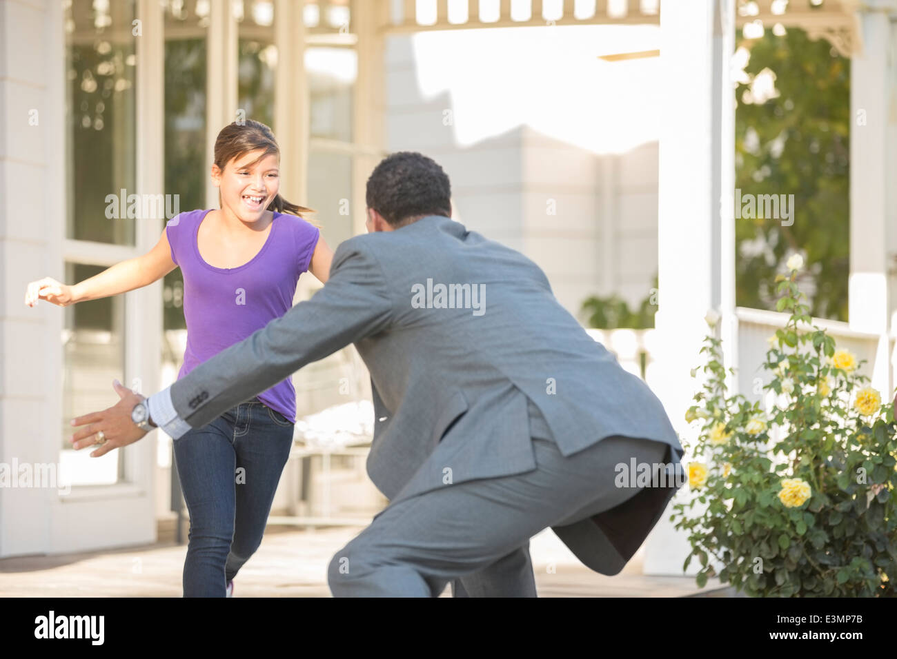 Daughter running to father Stock Photo - Alamy