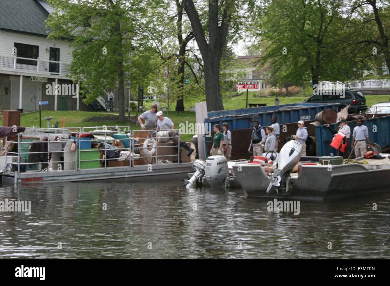 A full pontoon boat is seen near dumpsters during a Mississippi River ...