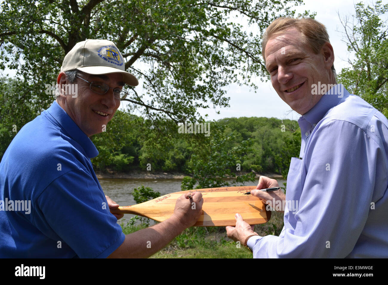 A paddle is signed by Tom Melius, Regional Director of the USFWS ...