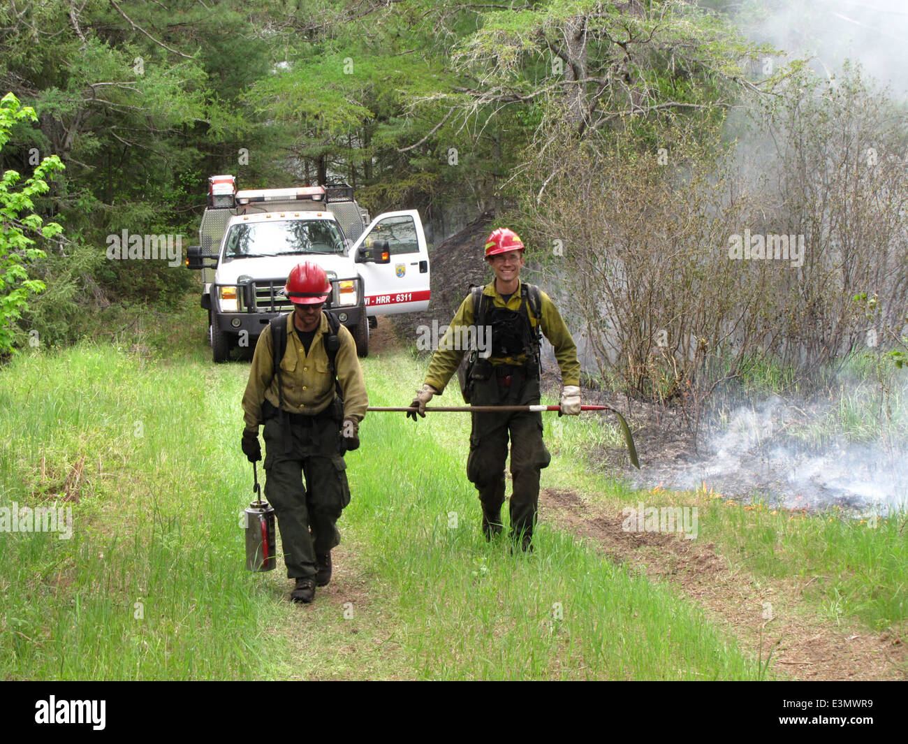 A hand crew from the U.S. Fish and Wildlife Service works to contain ...