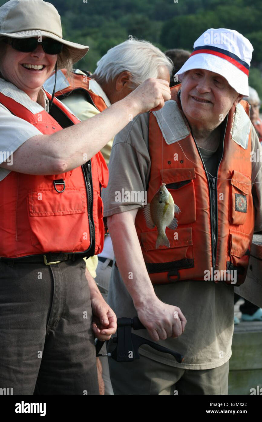 WB Reid helps a client from Project Compass during a fishing trip on ...