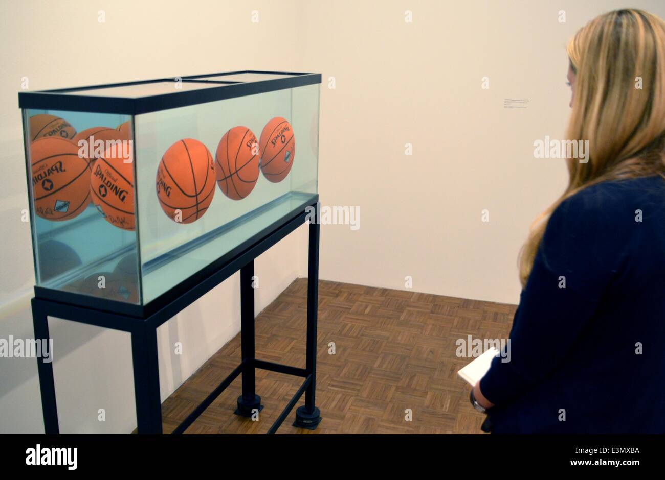 New York, USA. 24th June, 2014. A woman looks at the sculpture 'Three ...