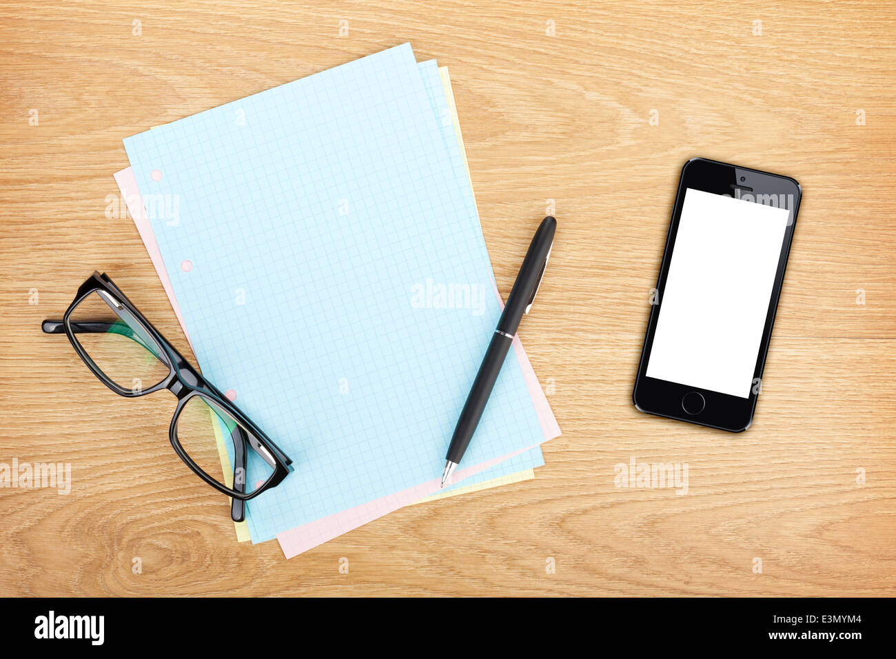 Blank lined paper with mobile phone, office supplies and glasses on ...