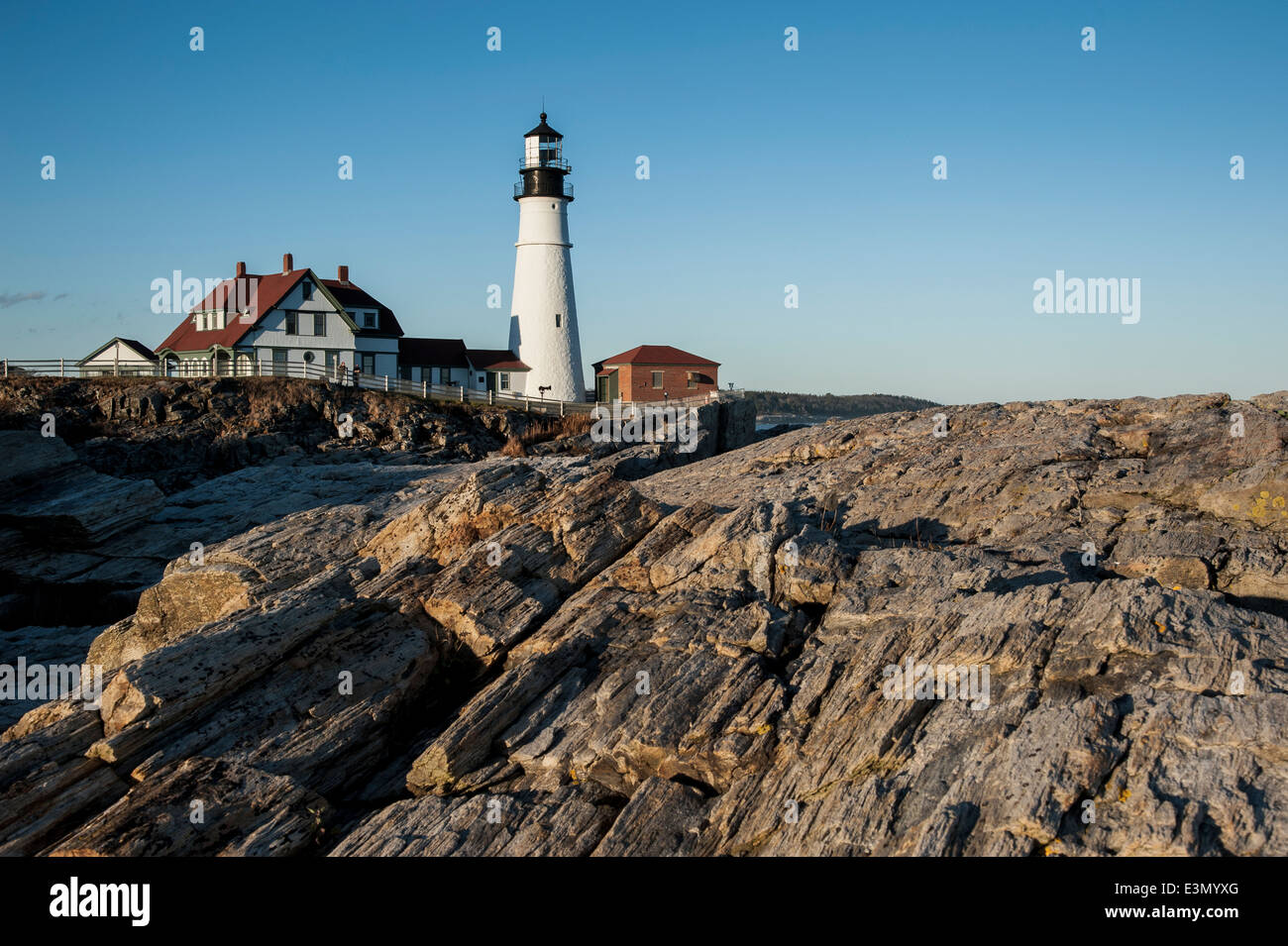 Portland Head lighthouse overlooks jagged rock formations that empty ...