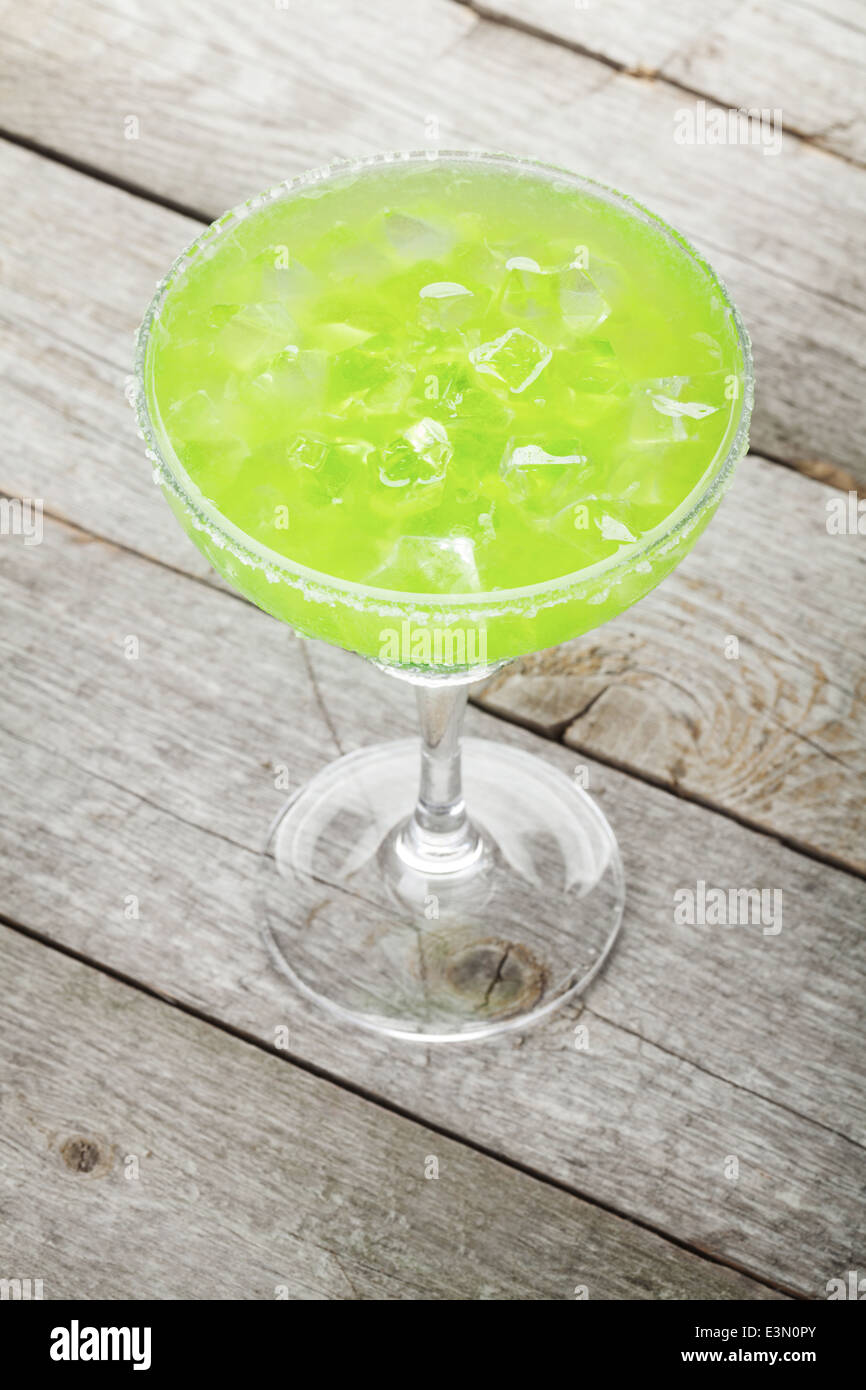 Classic margarita cocktail with salty rim on wooden table Stock Photo ...