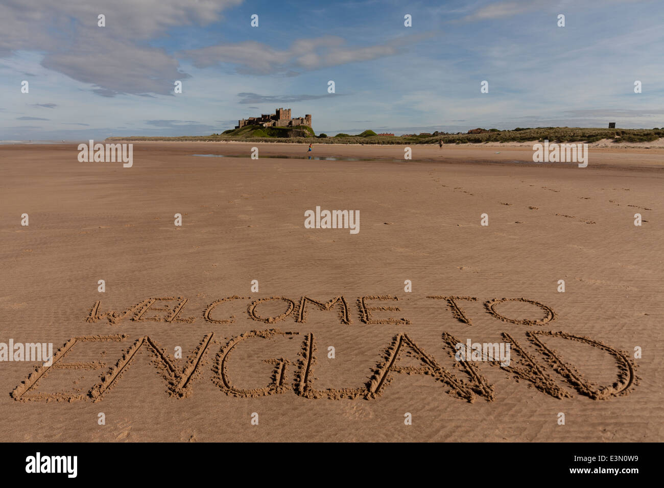 Welcome to England written in sand on beach at Bamburgh, UK with ...