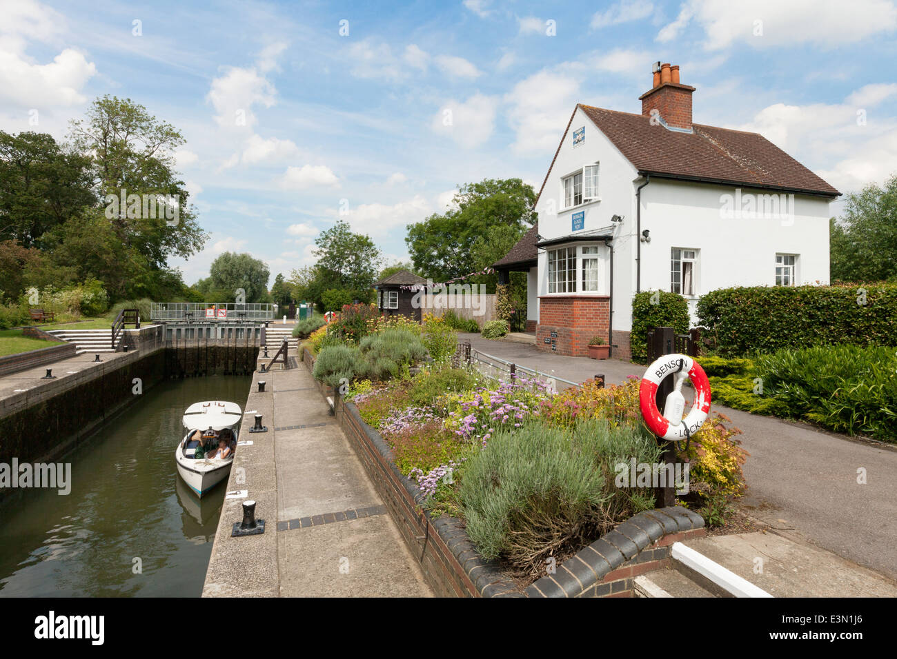 A boat in Benson Lock, with the lock house, River Thames, Oxfordshire ...