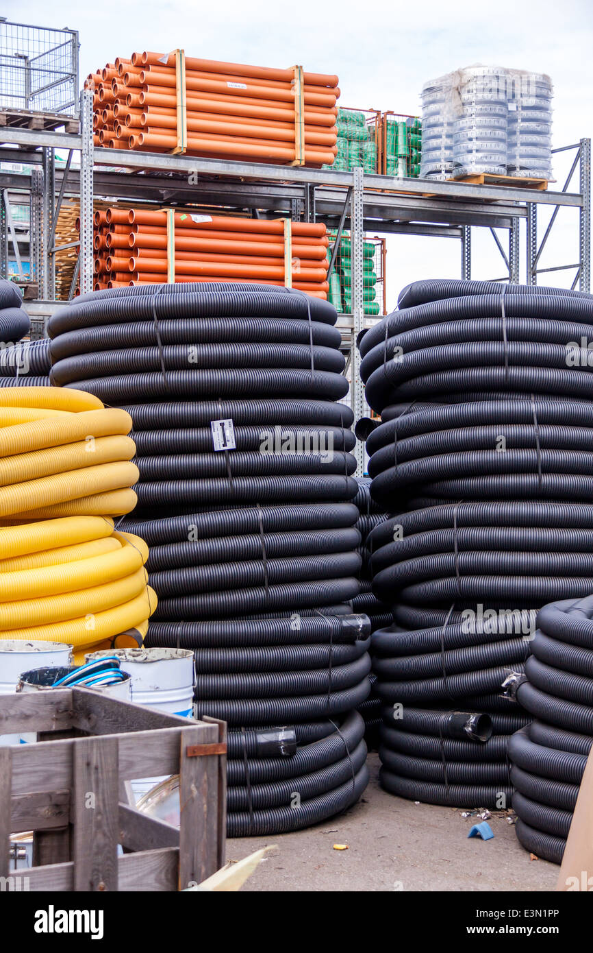 Several pipes in different colors and sizes stacked in yard Stock Photo ...