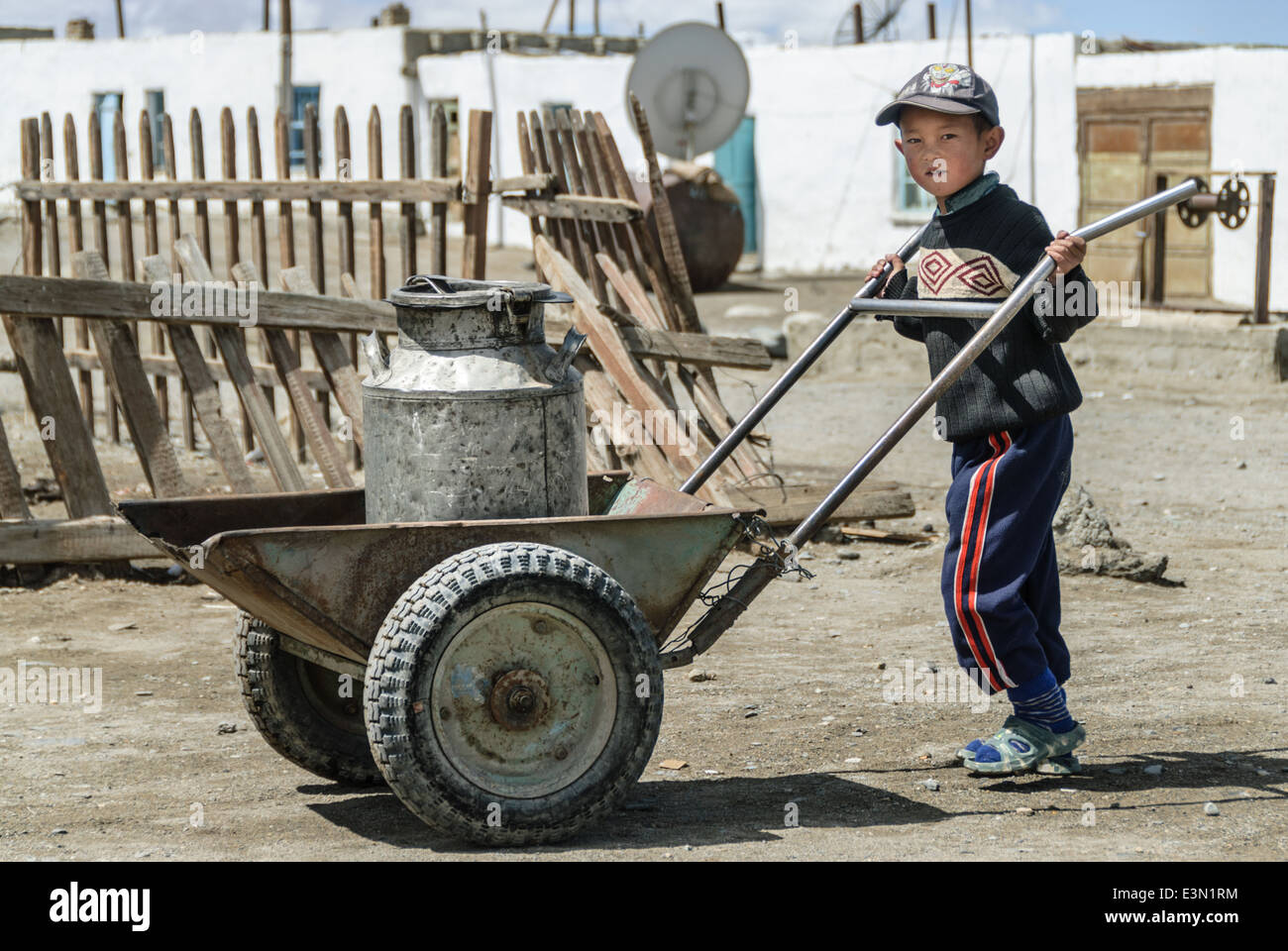 Boy carrying water on a wheelbarrow, Karakul lake, Pamir highway ...