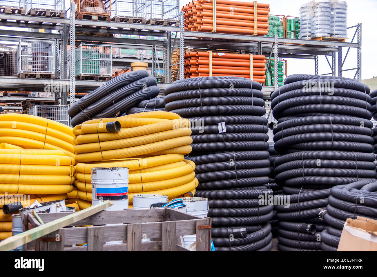 Several pipes in different colors and sizes stacked in yard Stock Photo ...