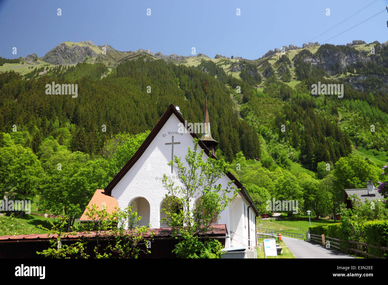 A white church with a steeple, amid mountain scenery Stock Photo - Alamy