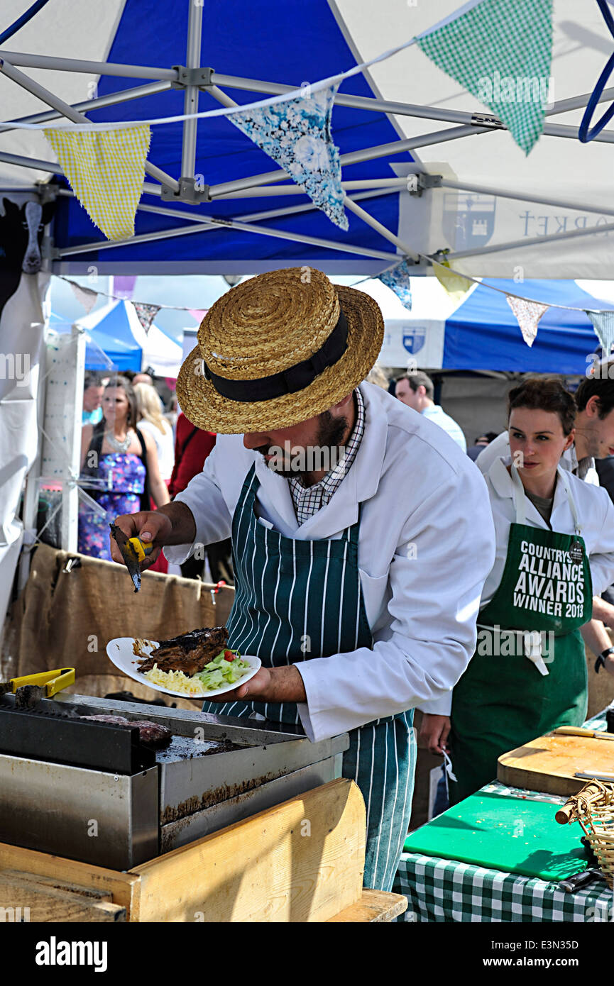 Chef preparing beef burgers on grill at outdoor fast food stall, Derry ...