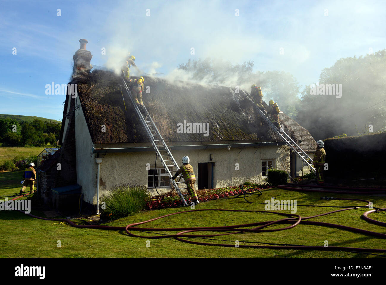 Thatched cottage fire, firefighters at a thatched cottage fire, UK ...