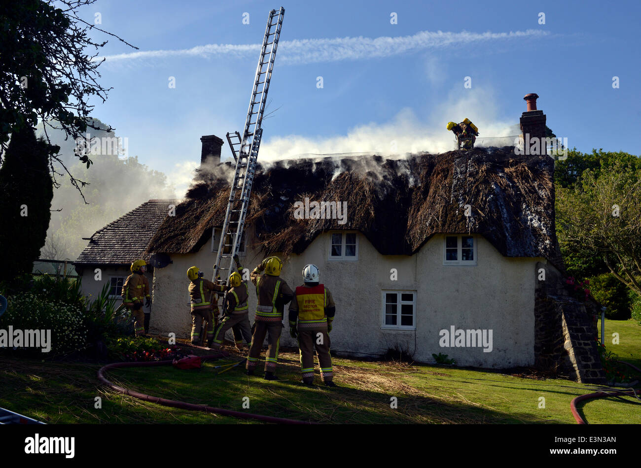 Thatched cottage fire, firefighters at a thatched cottage fire, UK ...