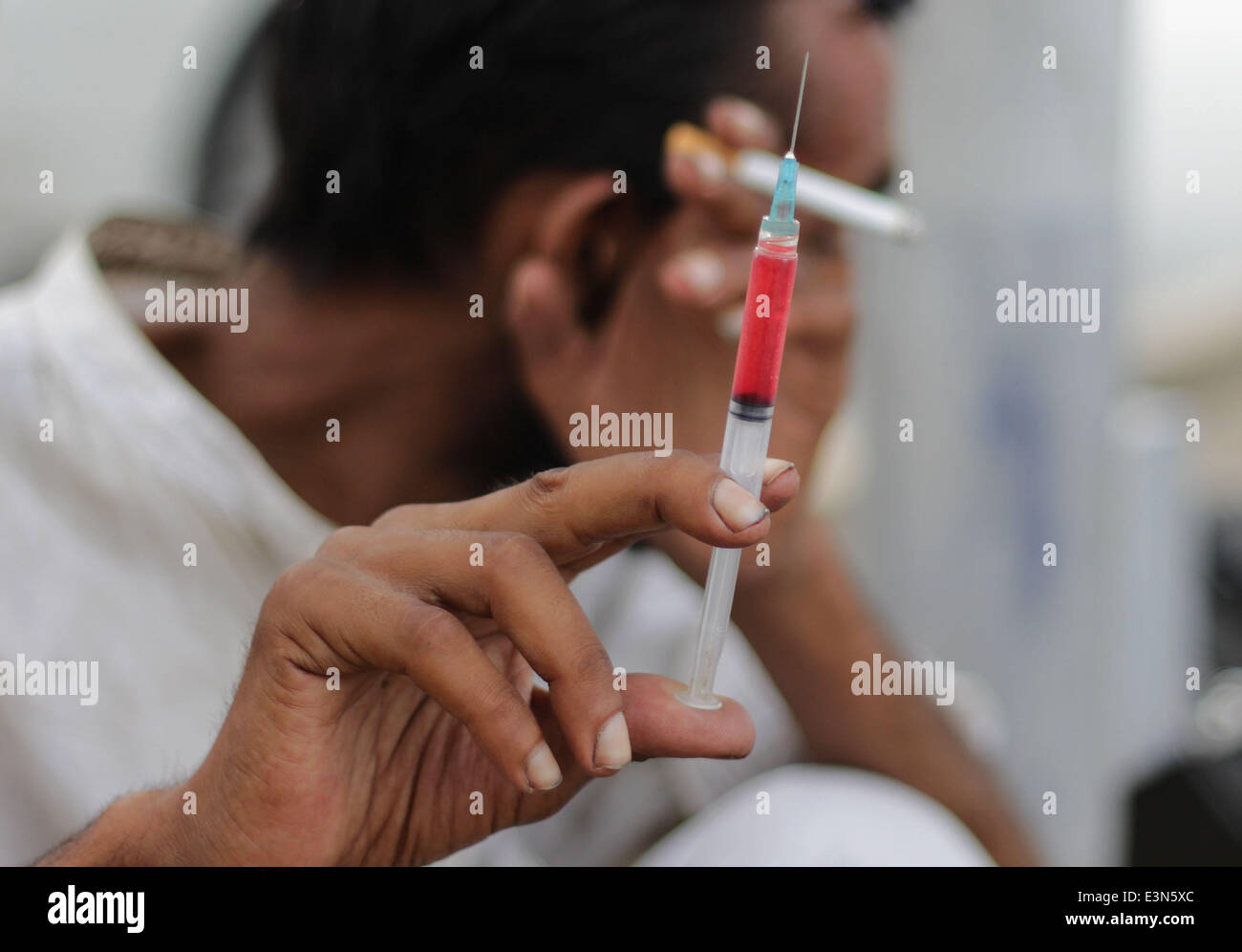LAHORE, PAKISTAN- JUNE 25,2014.: Pakistani Addict persons taking open ...