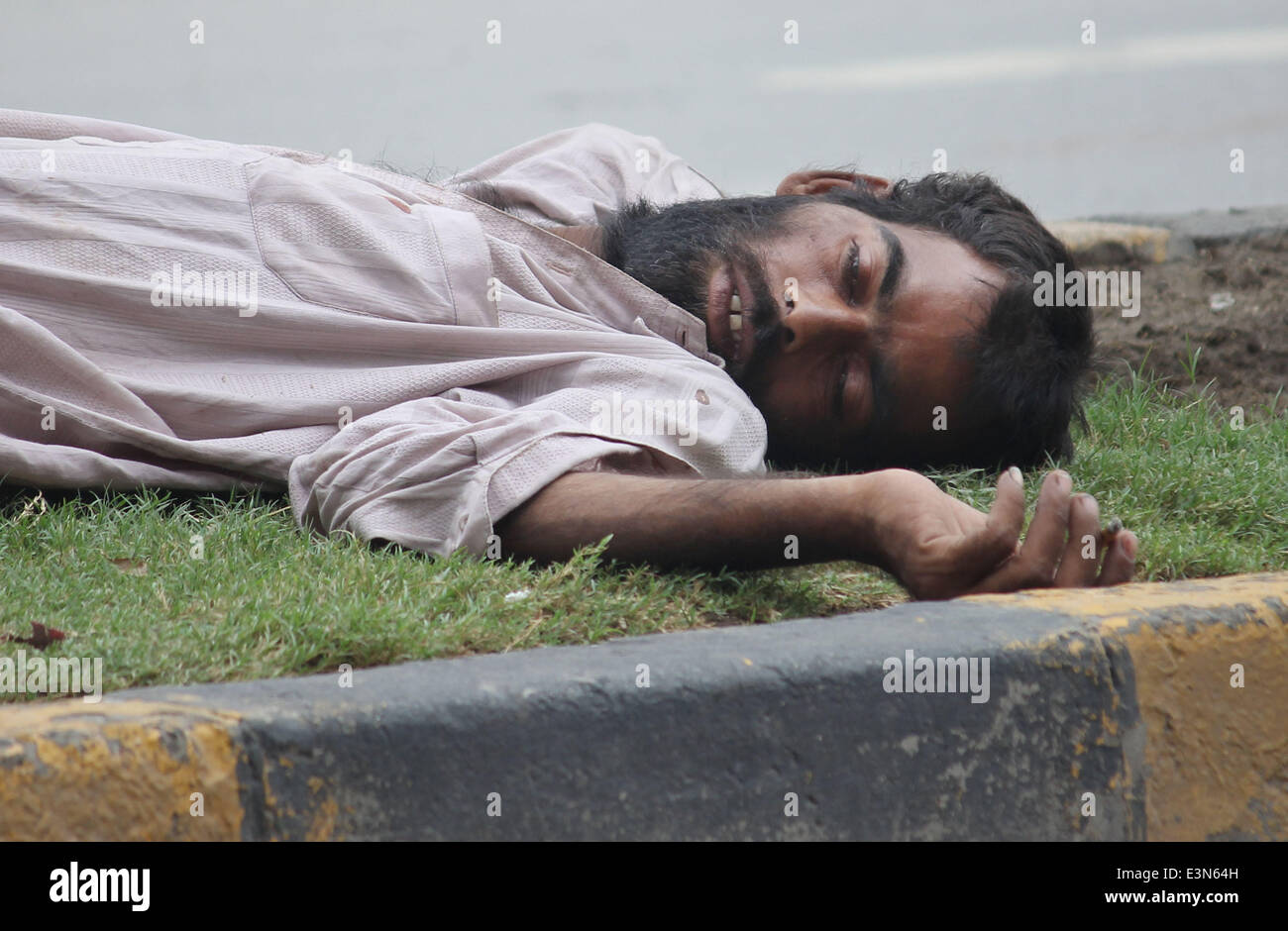 LAHORE, PAKISTAN- JUNE 25,2014.: Pakistani Addict persons taking open ...