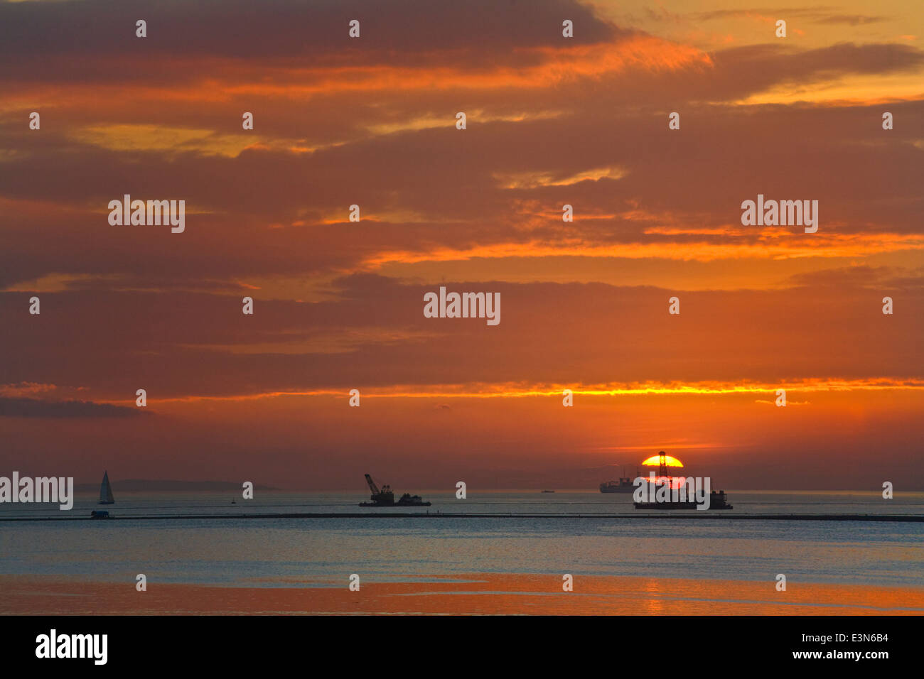 The sun sets behind ships and a dock in MANILA BAY - MANILA ...