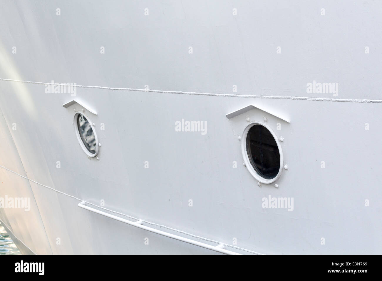 Portholes on the side of a tourist cruise ship Stock Photo - Alamy