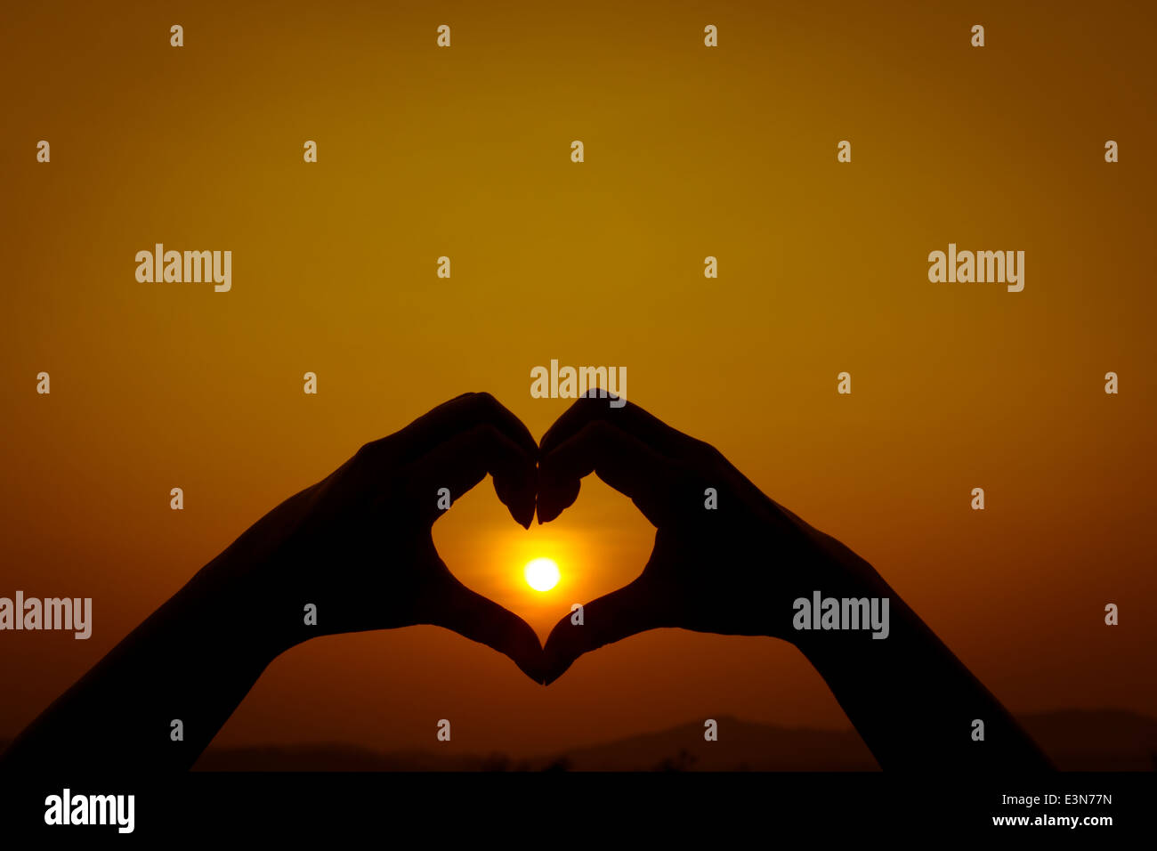 Heart shaped hand sunrise hi-res stock photography and images - Alamy
