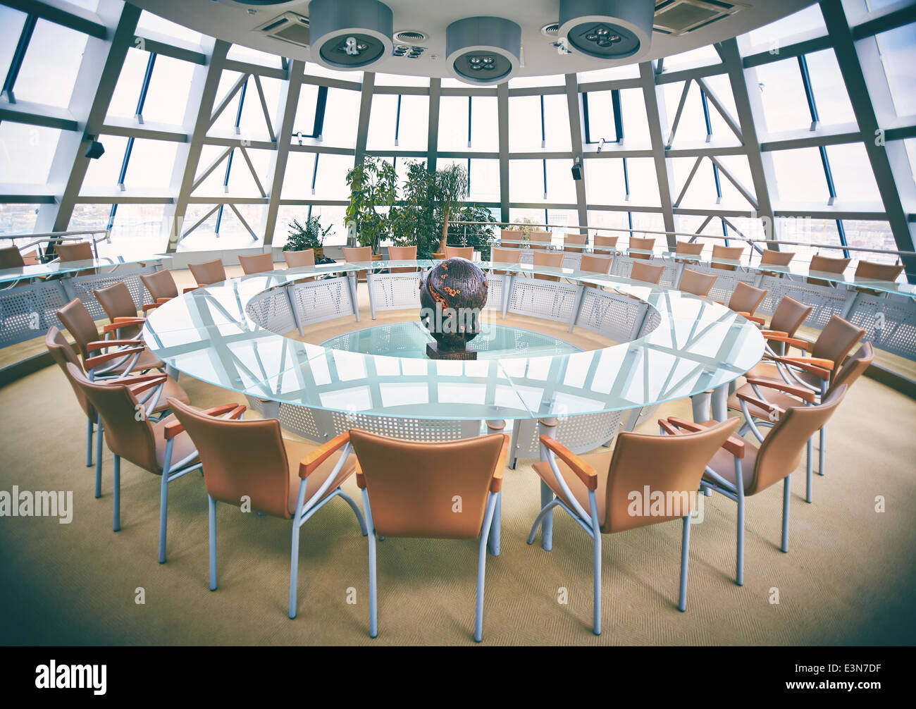 Conference hall with round table and chairs Stock Photo - Alamy