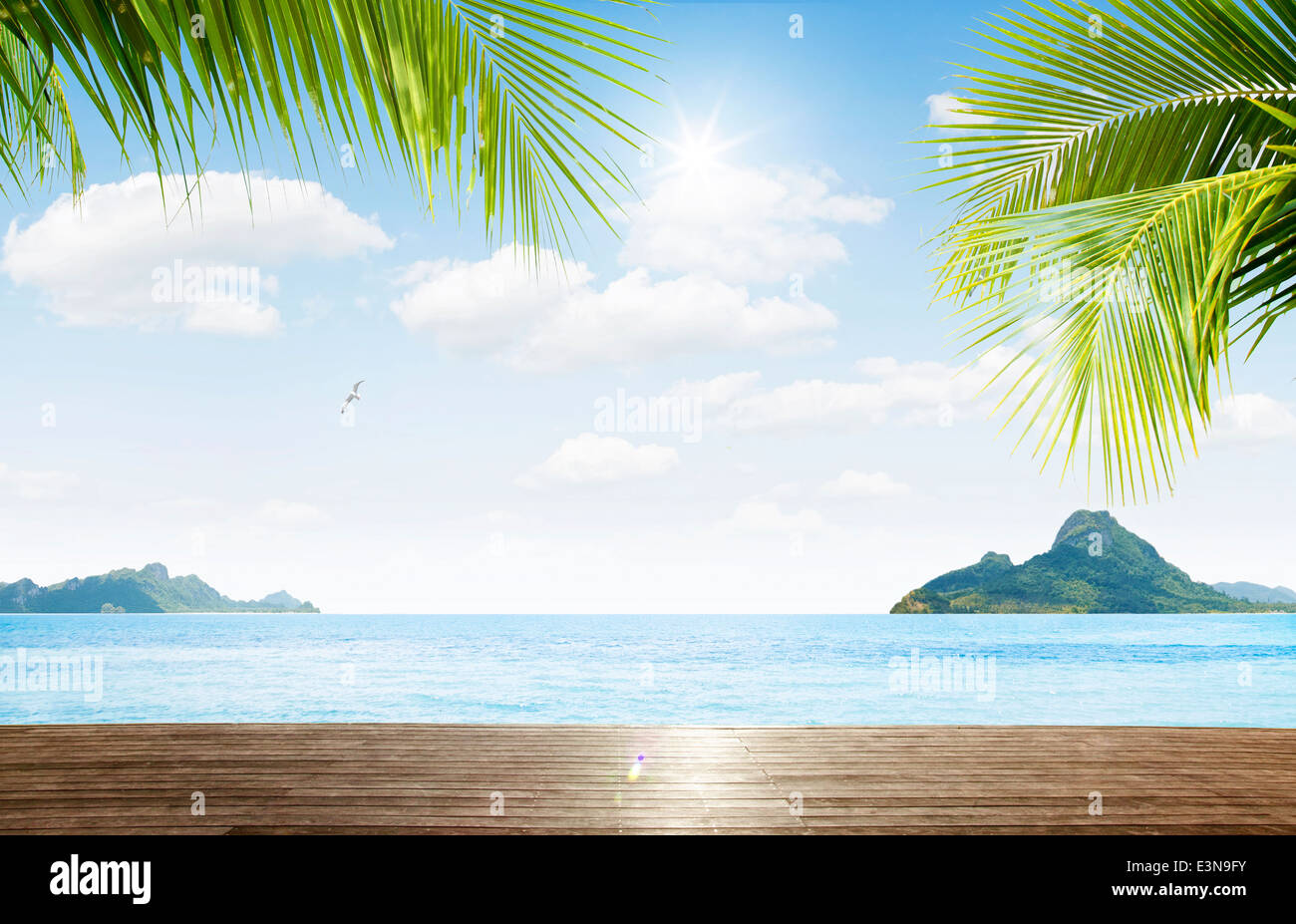 view of nice palms, blue ocean with tropical islands in the distance ...