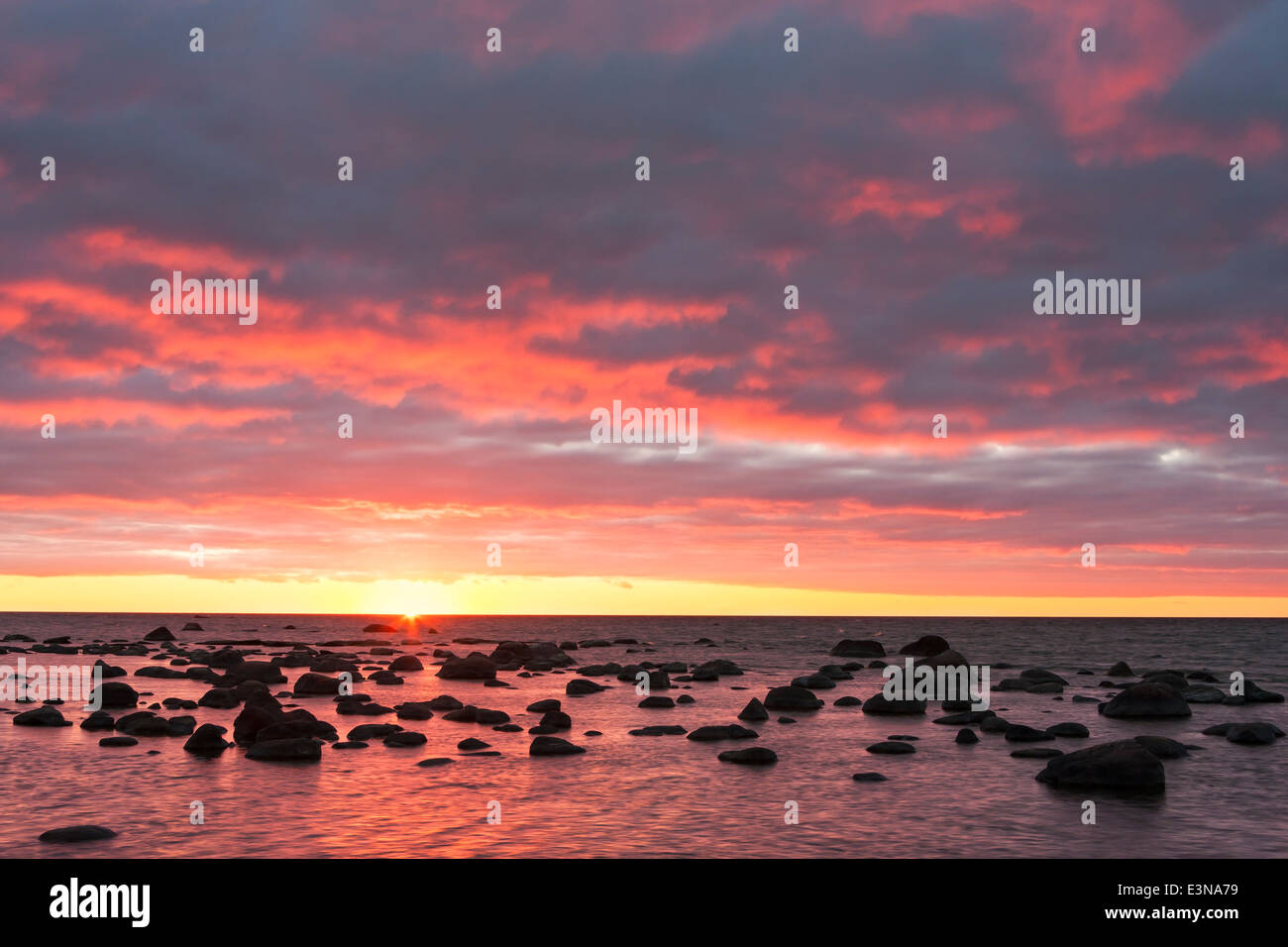 colorful sunset at sea under overcast sky Stock Photo - Alamy