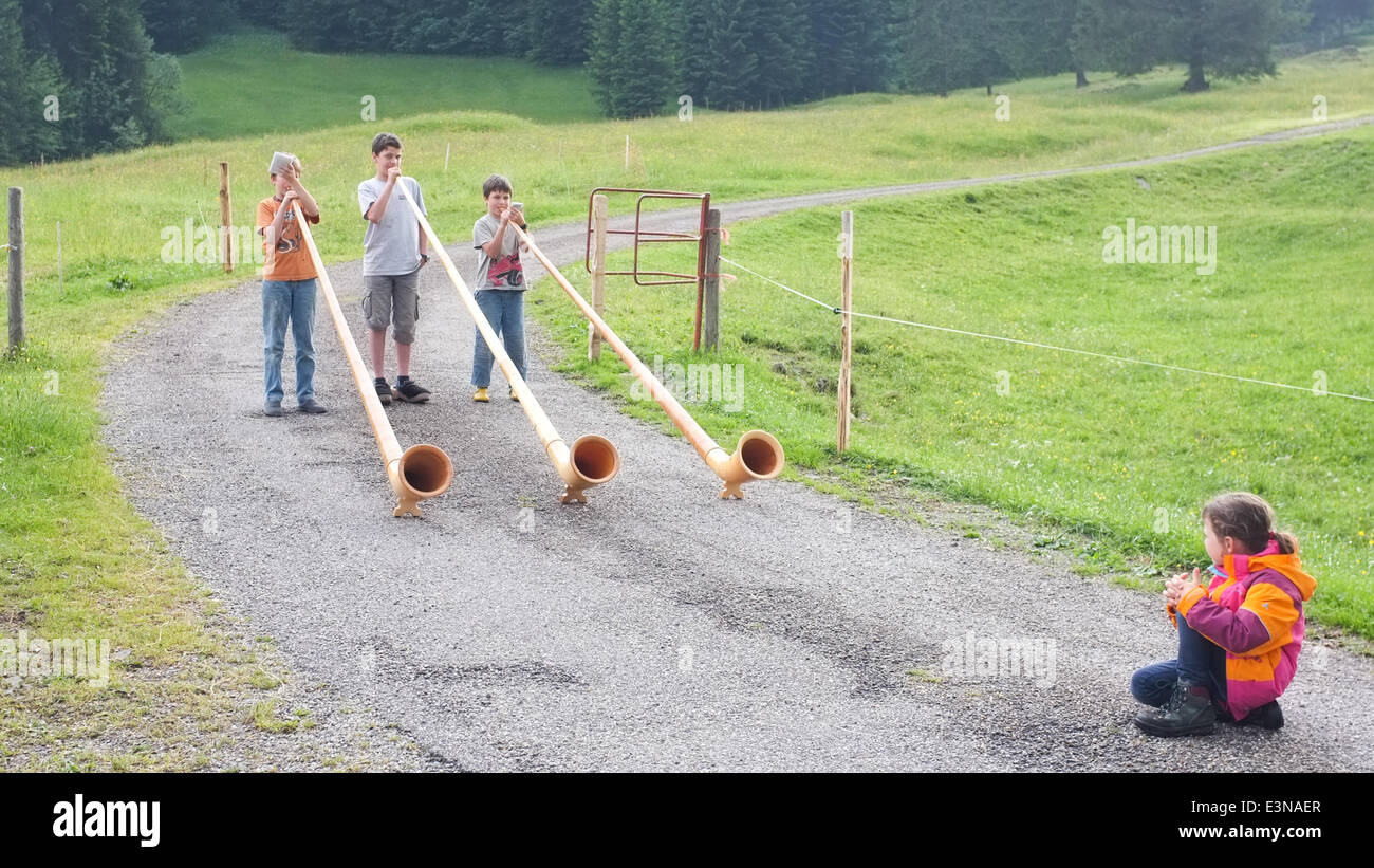 Three boys playing the alphorn - Bavaria - Germany - June 2014 Stock ...