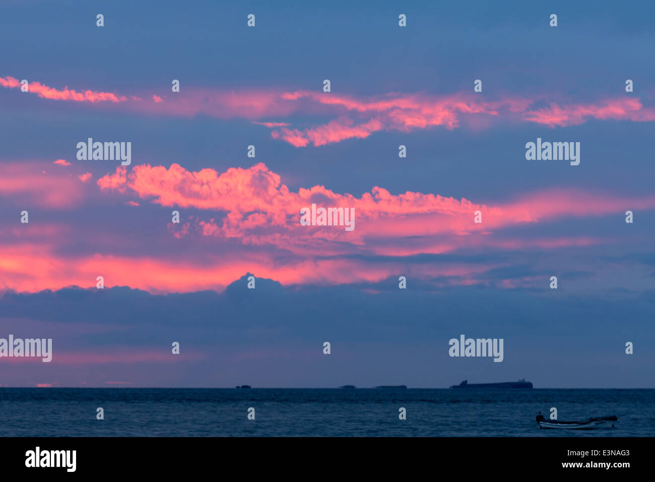 Pre-dawn light with crimson clouds forming over the Farne Islands ...