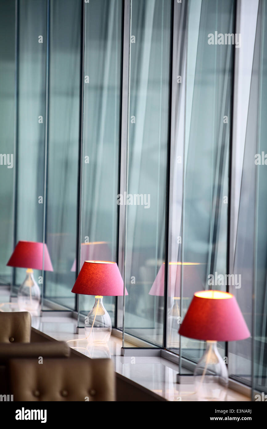 Interior with some lamps and tall windows Stock Photo - Alamy