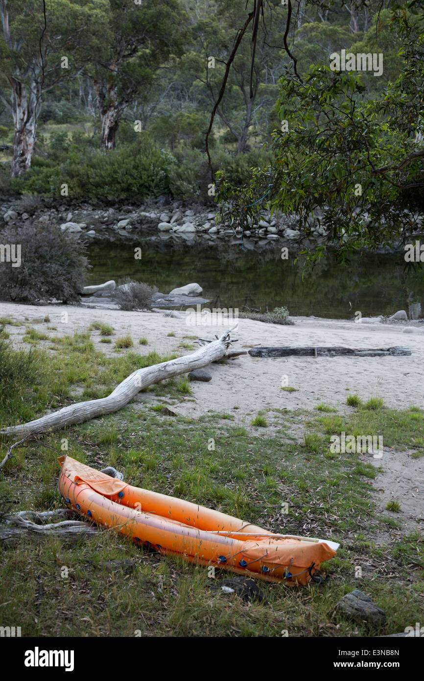 Abandoned inflatable raft on lakeshore Stock Photo - Alamy