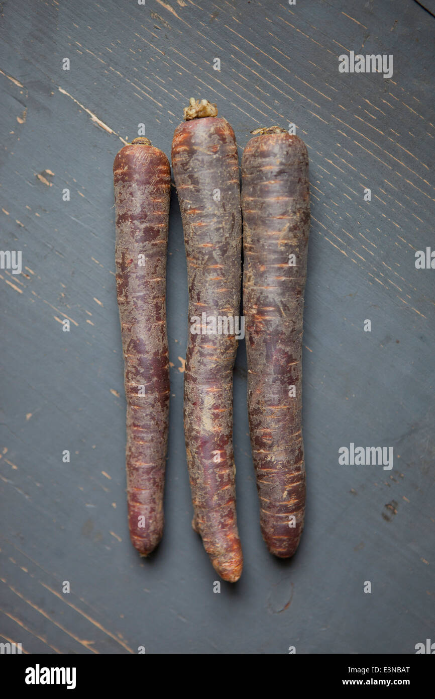Carrots on wooden table Stock Photo - Alamy