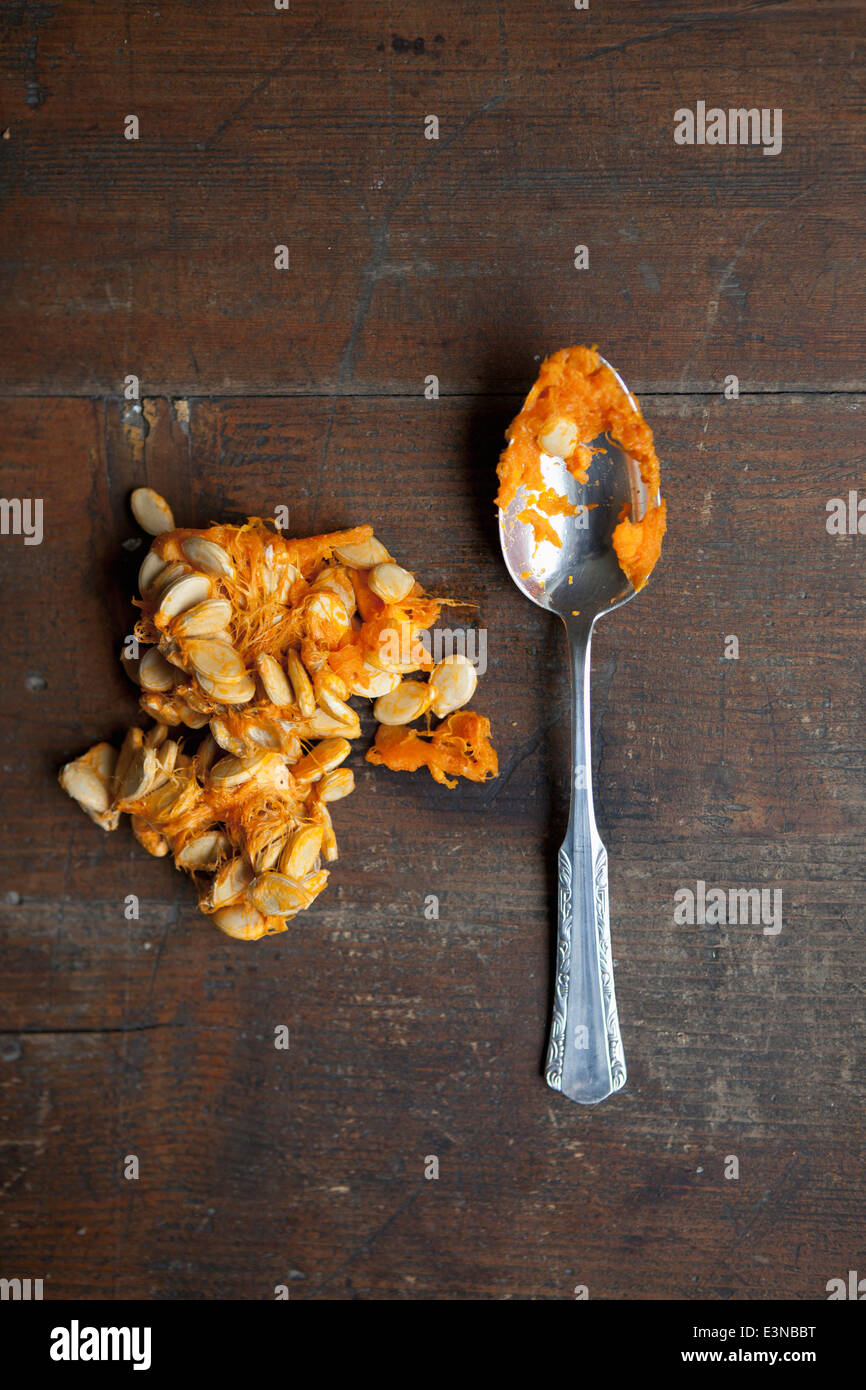 Directly above shot of squash seeds with spoon on table Stock Photo - Alamy