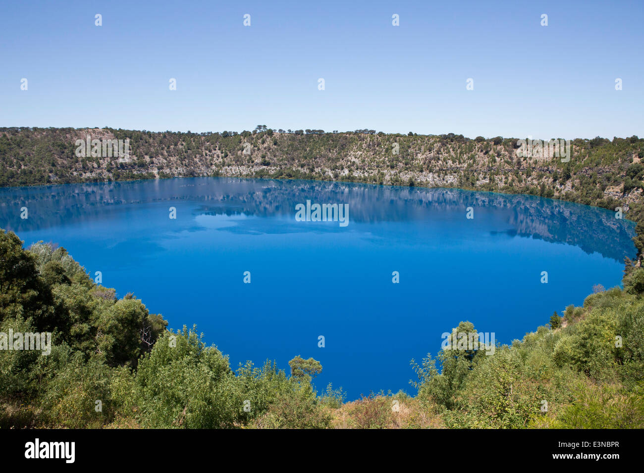Tranquil view of pond surrounded by landscape against clear sky Stock ...