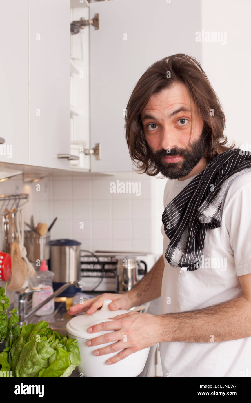 Portrait of man cooking in domestic kitchen Stock Photo - Alamy