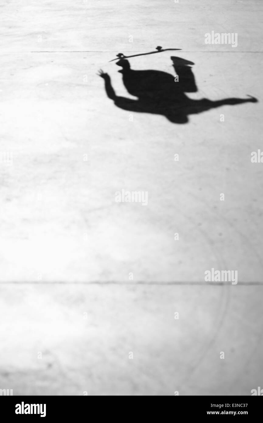 Shadow of person skateboarding in park Stock Photo - Alamy