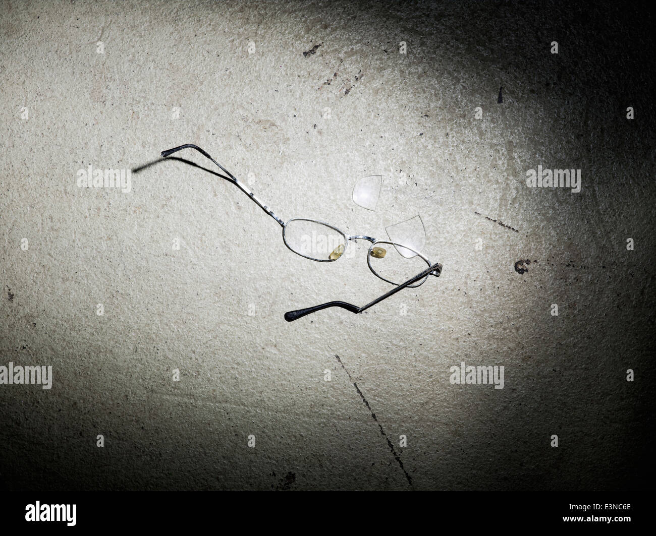 Broken eyeglasses on textured floor Stock Photo - Alamy