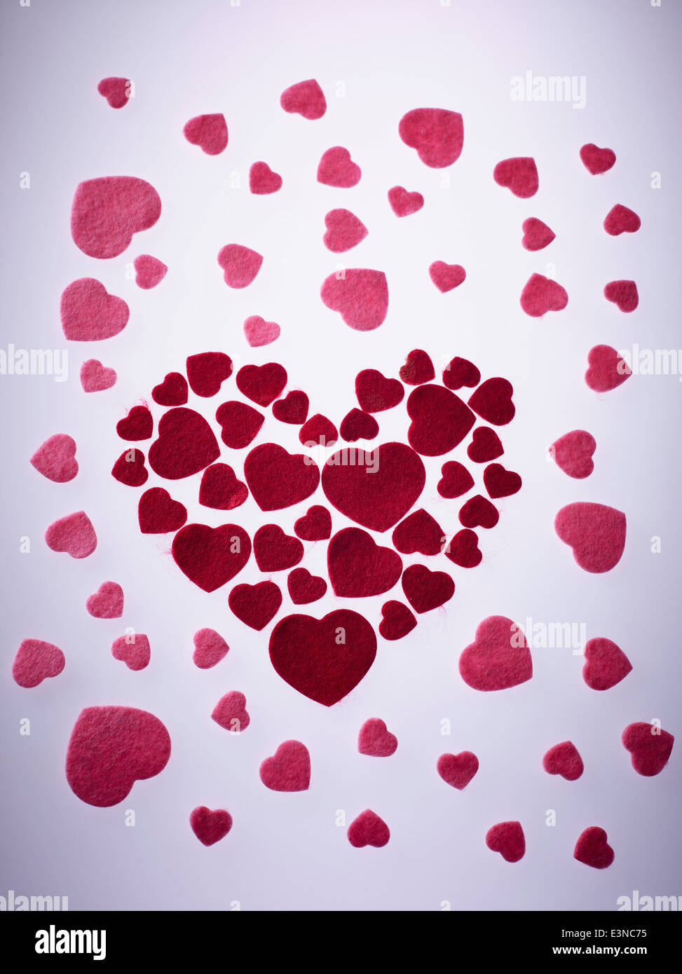 Velvet heart shapes over colored background Stock Photo - Alamy
