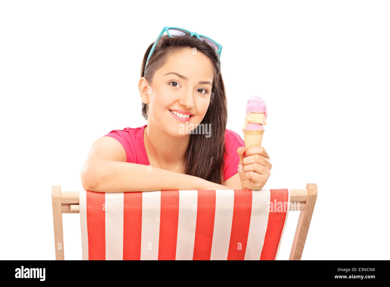 Woman eating ice cream seated on a sun longer Stock Photo - Alamy