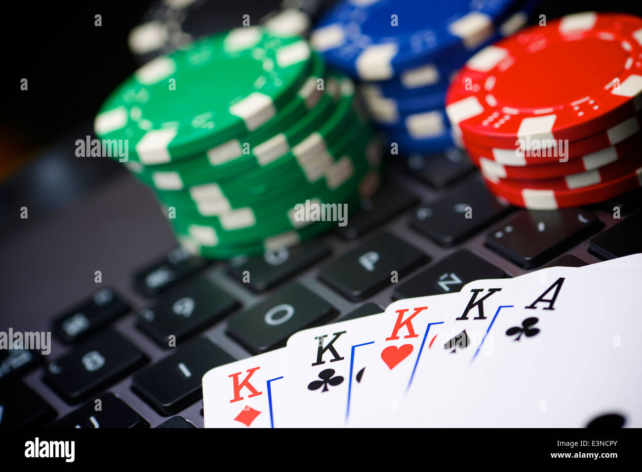 Casino chips and cards stacking on a laptop Stock Photo - Alamy