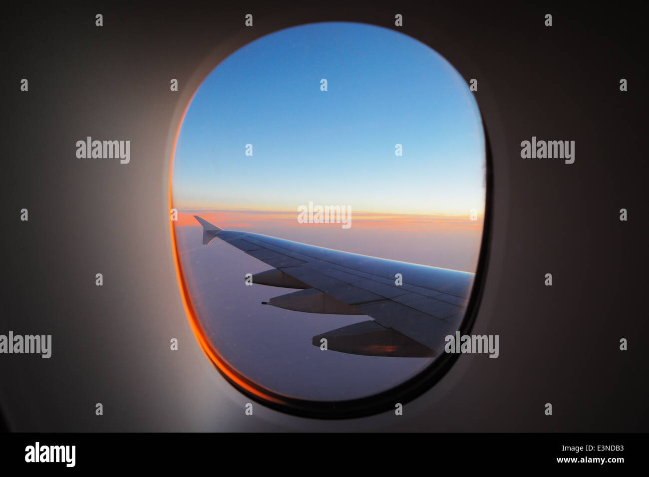 A window view of the wing of a modern luxury jet plane Stock Photo - Alamy