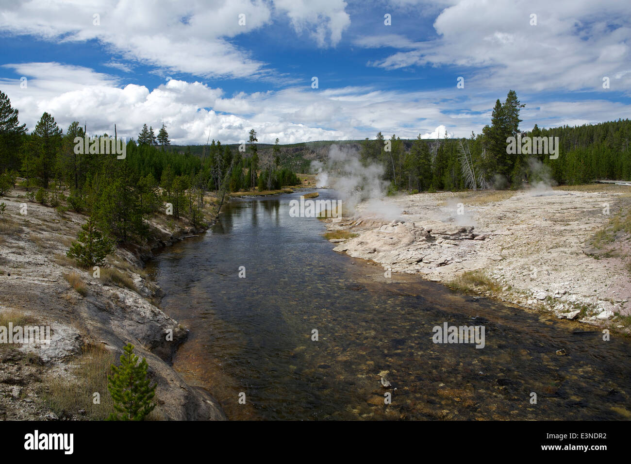 Steaming hot springs on the banks of Firehole River which flows through ...