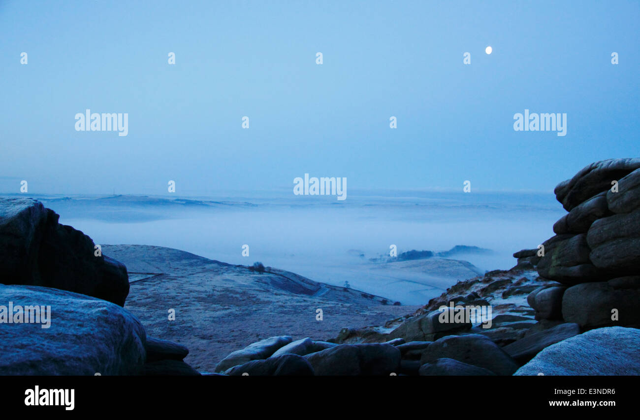 A glorious flush of blue pre-dawn light illuminates low lying cloud ...