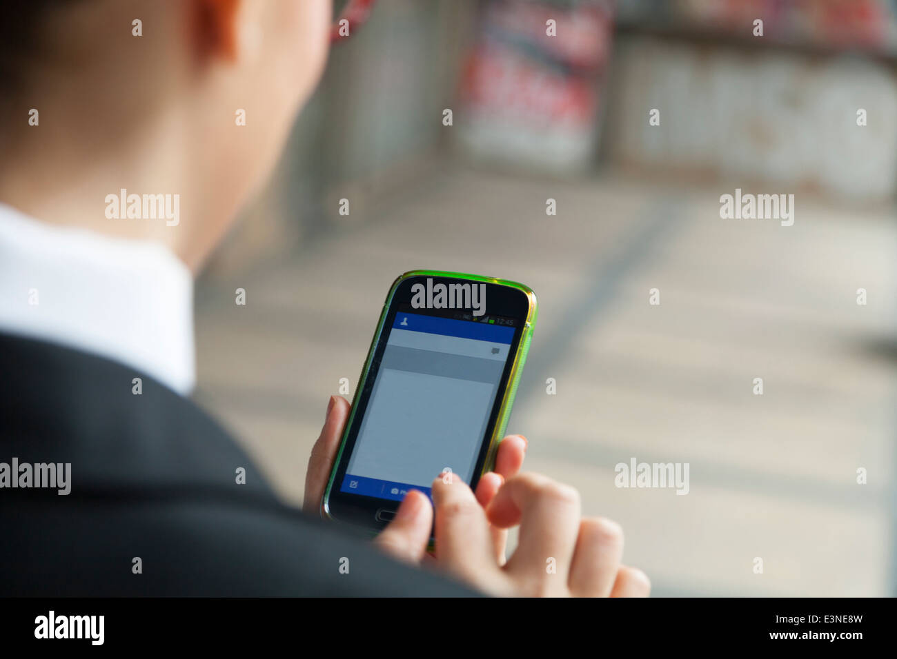 Using Smart Phone on street Stock Photo - Alamy
