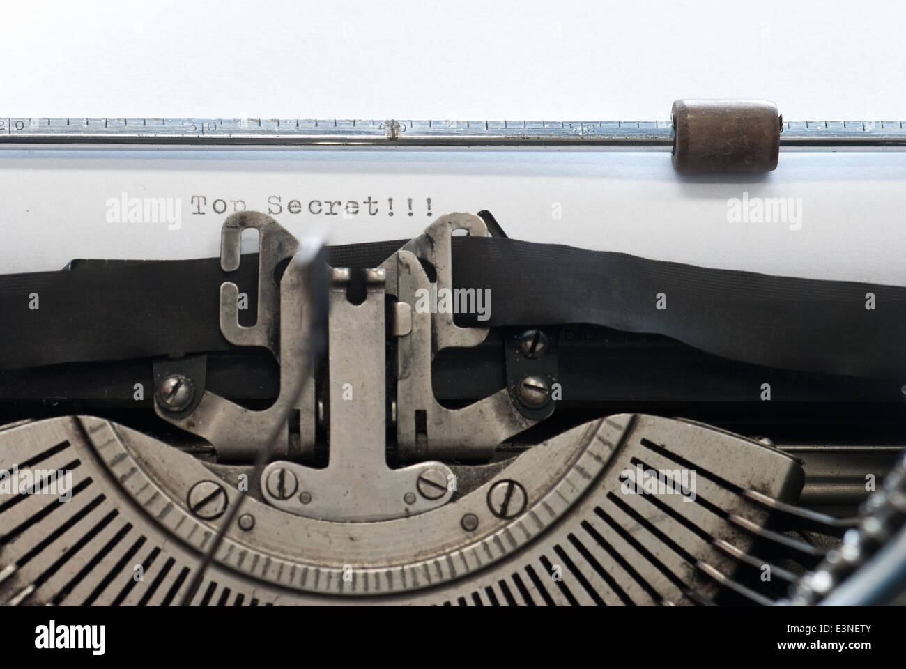 Closeup of paper sheet in vintage typewriter with top secret words ...