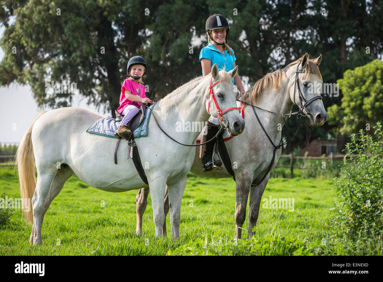 Two girls on ponies riding hi-res stock photography and images - Alamy