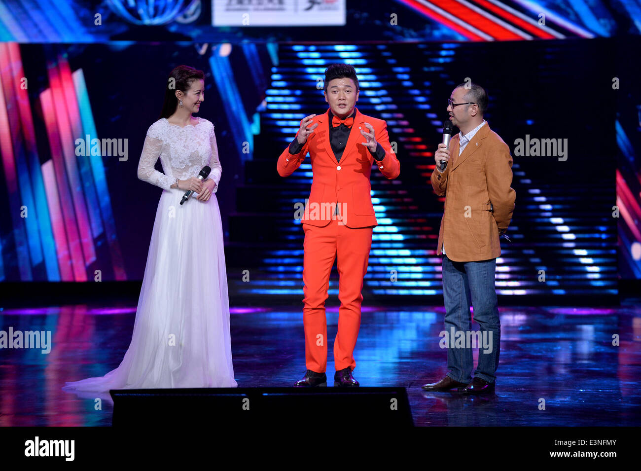 Beijing, China. 25th June, 2014. Director Xiao Yang (C) talks about his ...