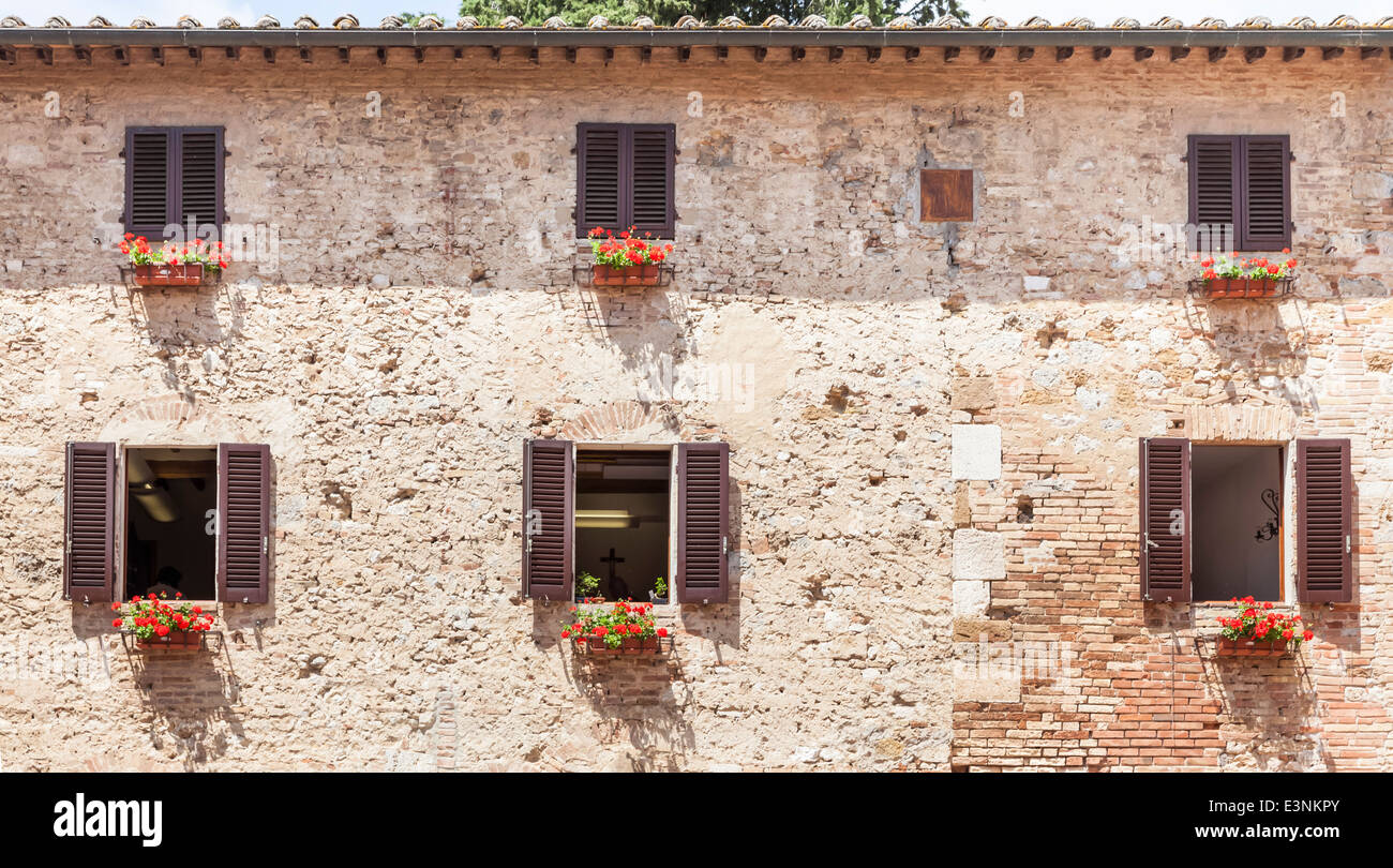 Windows and shutters with flowerpots in Castellini in Chianti, Tuscany ...