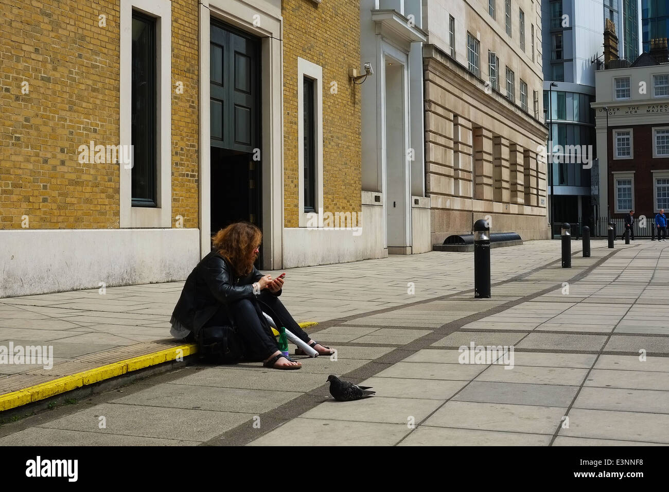 Sitting on the sidewalk Stock Photo - Alamy